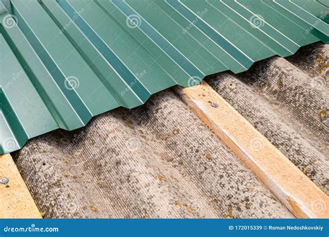 Laying A Metal Profiled Sheet On Asbestos Cement Sheets Stock Image
