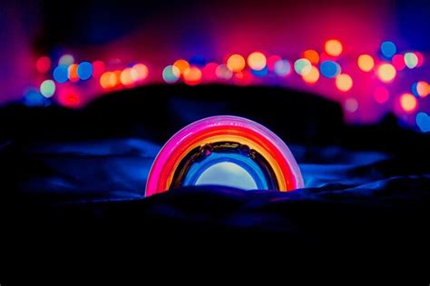 Premium Photo Close Up Of Multi Colored Condoms On Bed