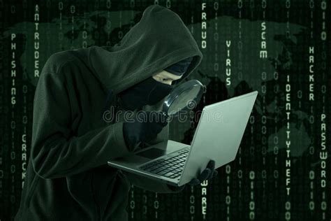 Hacker Man In Black Hood And Mask With Computer Laptop Hacking System