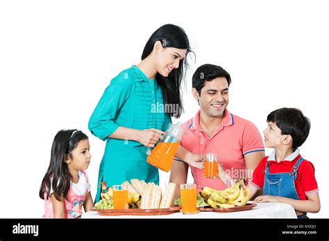 Parents And Children Healthy Food Dining Table Mother Serving Juice Breakfast Stock Photo - Alamy