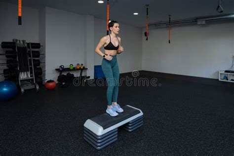 Fit Female Executing Step Ups On Training Platform Strengthening Lower Body And Boosting