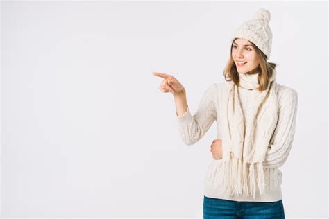 Free Photo Woman In Warm Clothes Pointing Aside