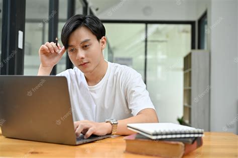 Premium Photo Smart Asian Male Concentrating Doing His Work Project