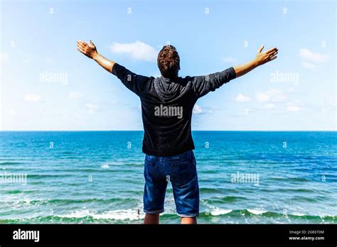 Caucasian Man Spreading Arms And Watching The Ocean Happy Man With Outstretched Arms Man With