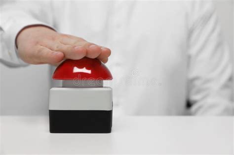 Man Pressing Red Button Of Nuclear Weapon At White Table Closeup With