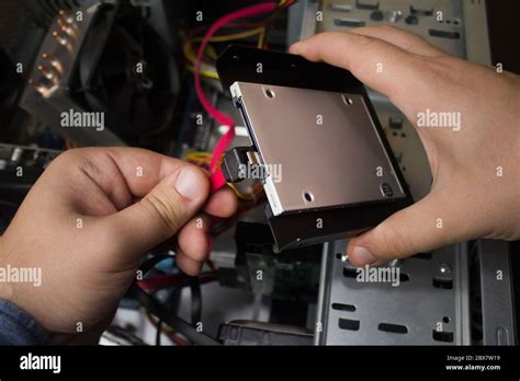 First Person View Hands Connecting SSD Drive Cables To A Motherboard Stock Photo Alamy