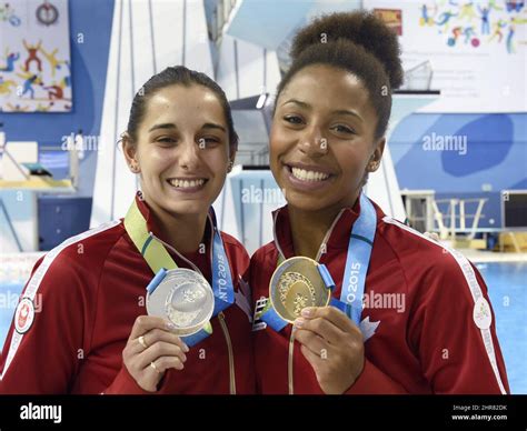 Pamela Ware Left And Jennifer Abel Of Canada Smile And Hold Up Their