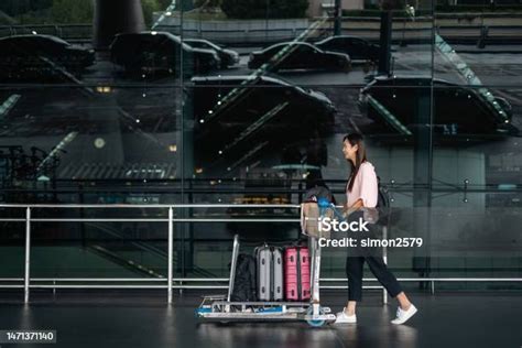 공항에서 여행하고 공항 터미널에서 여행 가방을 들고 있는 아시아계 중국인 여성 공항 탑승수속에 대한 스톡 사진 및 기타 이미지