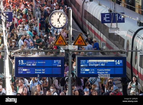 Many People Standing Crowded On A Platform In Front Of An ICE Train