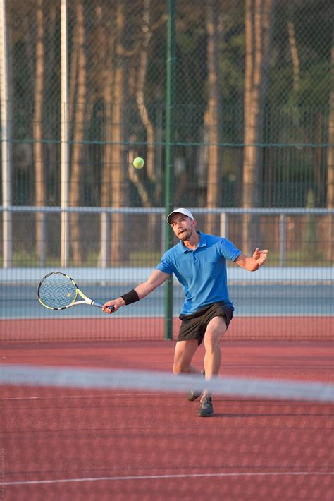 Male Tennis Player Hitting The Ball With Forehand Stroke Technique By