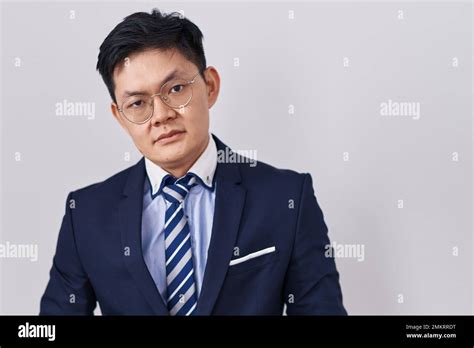 Young Asian Man Wearing Business Suit And Tie Looking Sleepy And Tired