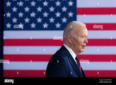 President Joe Biden Speaks To A Crowd With A Large American Flag