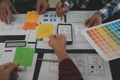 Premium Photo Close Up Ux Developer And Ui Designer Brainstorming About Mobile App Interface