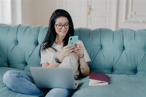 Happy Female Blogger Chats With Friends In Social Netwoks Works On