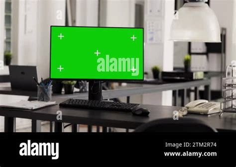 Empty Office Desk With Pc Running Greenscreen On Display Showing Isolated Chromakey Template In