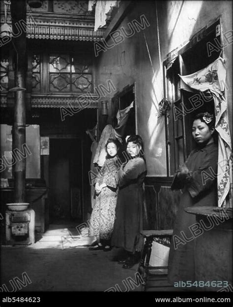 China Three Prostitutes Stand Outside The Doors To Their Rooms At A