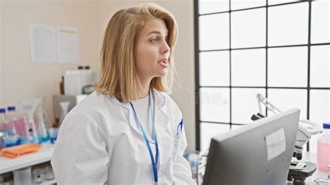 A Professional Woman In A Lab Coat Researches In A Clinical Laboratory