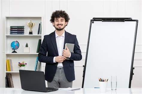 Free Photo Teacher Brunette Instructor With Computer In Suit And Whiteboard In Classroom