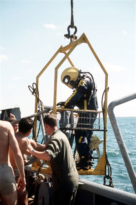 Crew Members Of The Salvage Ship Uss Preserver Ars 8 Assist A Diver