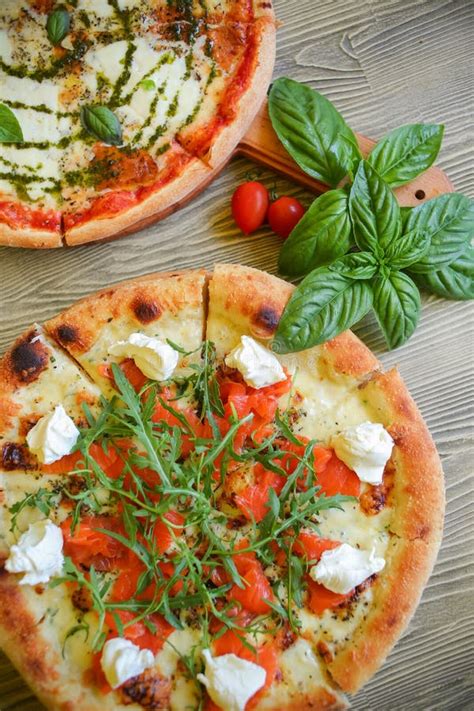 Raw Pizza Rolled Out Dough On A Cutting Board With Tomato Paste