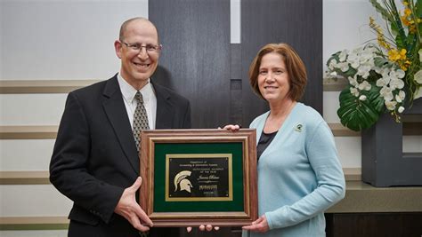 Jerry Behar And Chris Hogan Holding Award