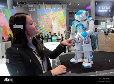 A Stand Hostess Touches A Nao Watson Robot At The Ibm Stand At The