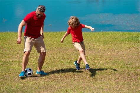 Premium Photo Father With Son Playing Football At Field Father And