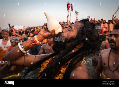 Naga Sadhu Indian Holy Man Blowing Into A Conch Shell And Bathing In