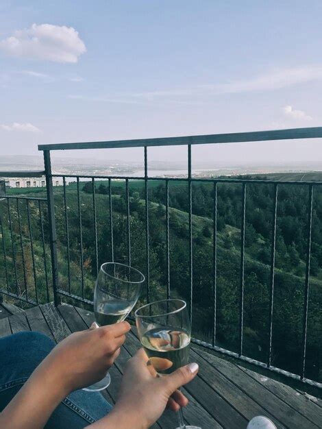 Premium Photo Man Holding Glass Of Water Against Sky