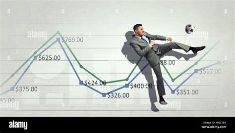 Businessman In Jump Kicking Ball And Graphs At Background Mixed Media