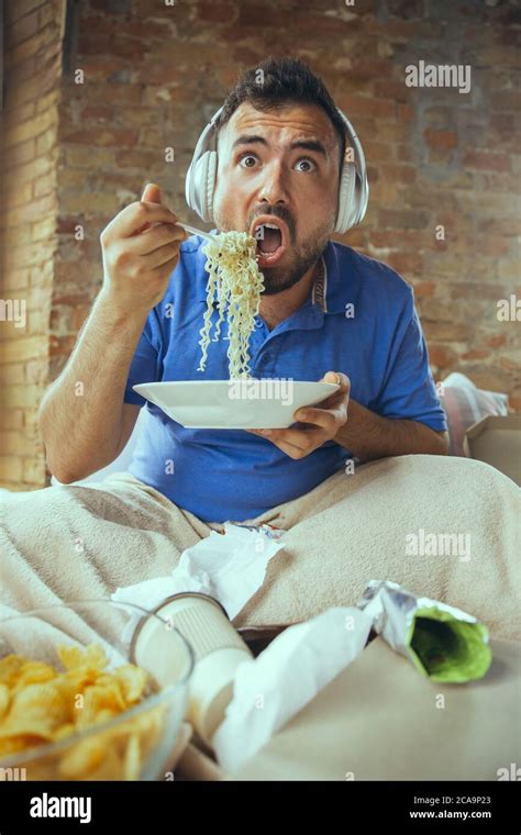 Shocked Eating Instant Noodle Watching Tv Lazy Man Living In His Bed Surrounded With Messy No