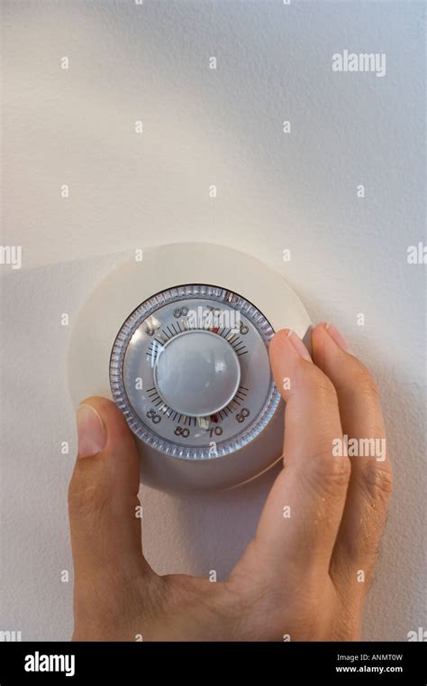 Man Adjusting Thermostat Stock Photo Alamy