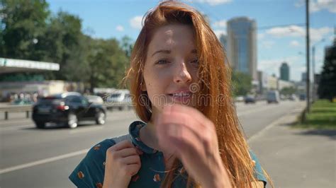 Beautiful Ginger Teenager Looking At Camera And Touching Hair Smiling