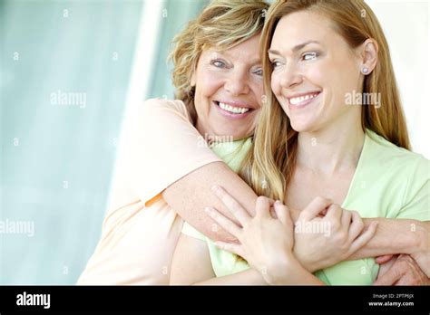 Receiving A Big Hug From Mom A Beautiful Woman Receiving An
