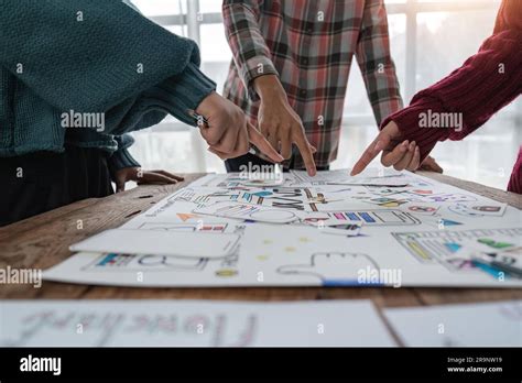Ux Developer And Ui Designer Brainstorming About Mobile App Interface Wireframe Design At Modern