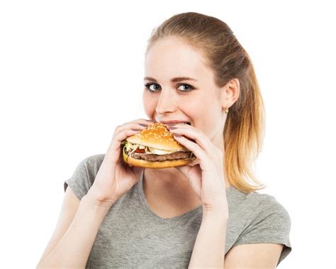 Premium Photo Portrait Of A Cute Young Woman Eating A Burger Isolated