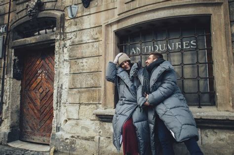 Classy Groom And His Gorgeous Bride Pose Outside In Winter Coats Stock