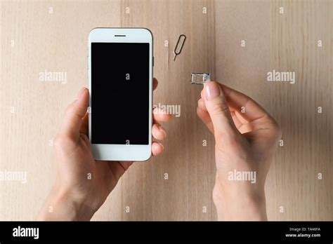 Woman Inserting Sim Card Into Mobile Phone Top View Stock Photo Alamy