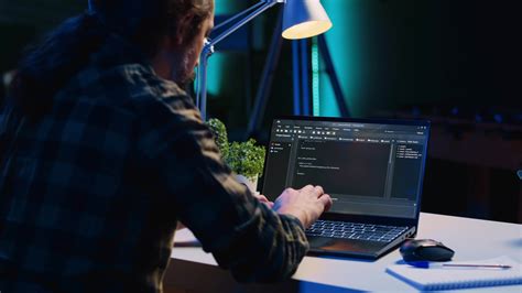Skilled Computer Scientist Writes Code On Laptop Screen While In Living