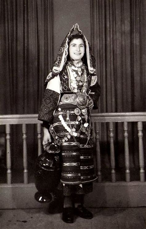 An Old Black And White Photo Of A Woman In Traditional Dress