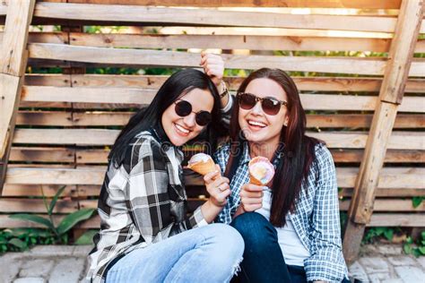 Two Pretty Brunette Girls Eating Ice Cream Outdoor Stock Image Image