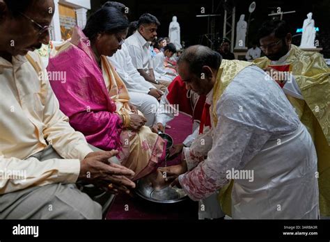 Cardinal And Archbishop Of Hyderabad Poola Anthony Washes The Feet Of A Church Member During A