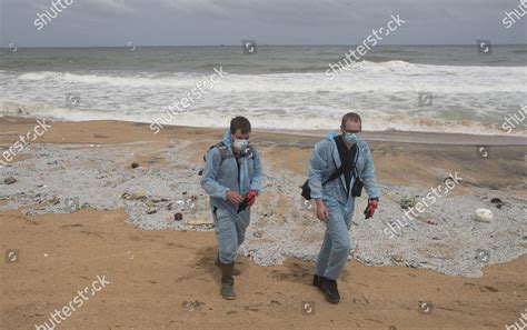 Unidentified Foreign Investigators Inspect Debris Washed Editorial