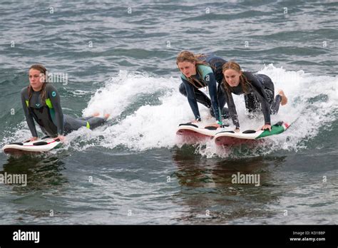 Three Teenage Girls On Their Surfboards Surfing The Wavessydney