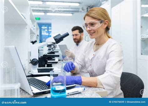 Mature Female Scientist In White Coat At Work Laboratory Assistant