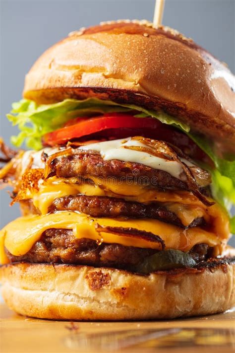 Loaded Cheeseburgers Three Triple Stacked Patties Stacked High With Layers Of Cheese Lettuce