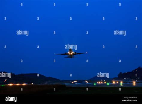 Passenger Airplane Take Off From Runways At Night Stock Photo Alamy