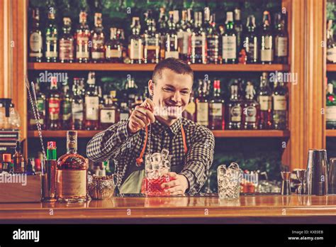 Barman Making An Alcoholic Cocktail At The Bar Counter On The Bar