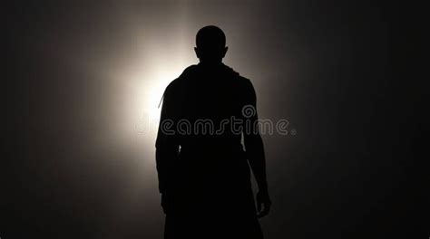 A Silhouette Of A Man Standing In Front Of The Sun Generated Stock