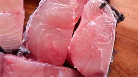 Fresh Boneless Skinless Cod Filet On Chopping Board 48020075 Stock